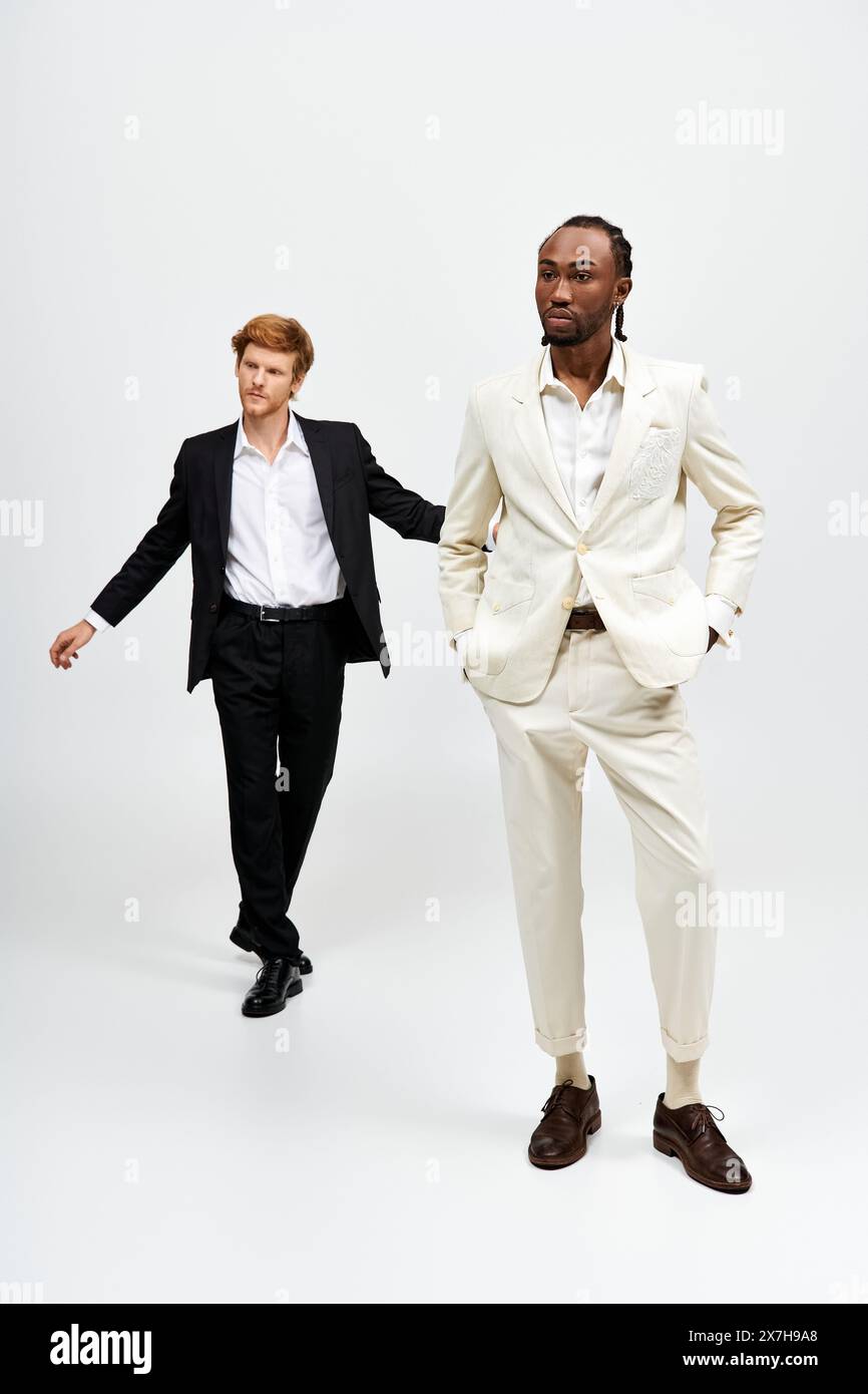 Two handsome multicultural men in stylish suits standing confidently ...