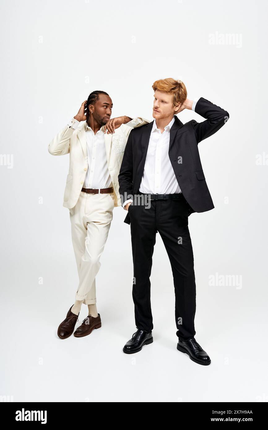 Handsome multicultural men in elegant suits posing together Stock Photo ...