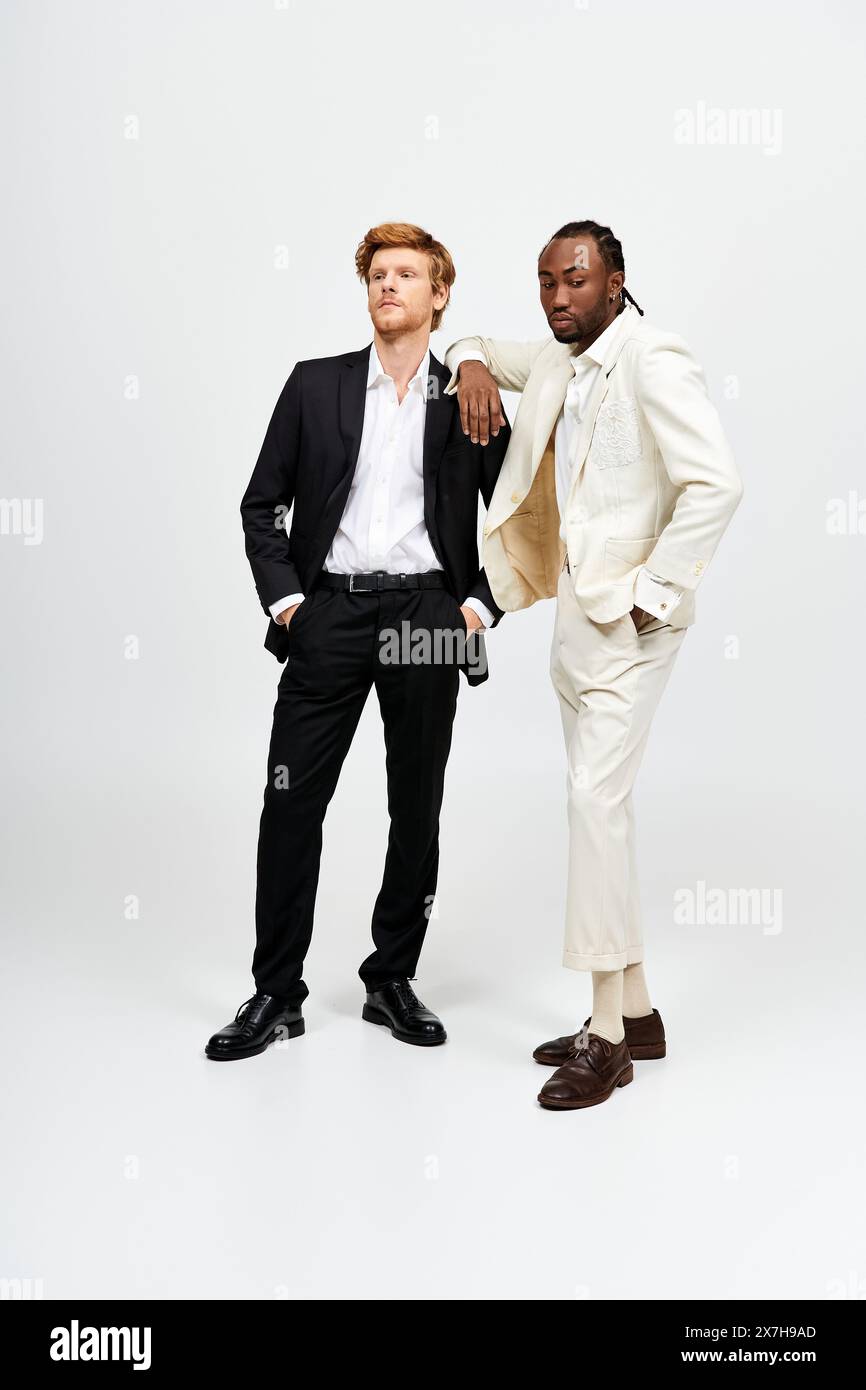 Two handsome multicultural men in elegant suits standing together Stock ...