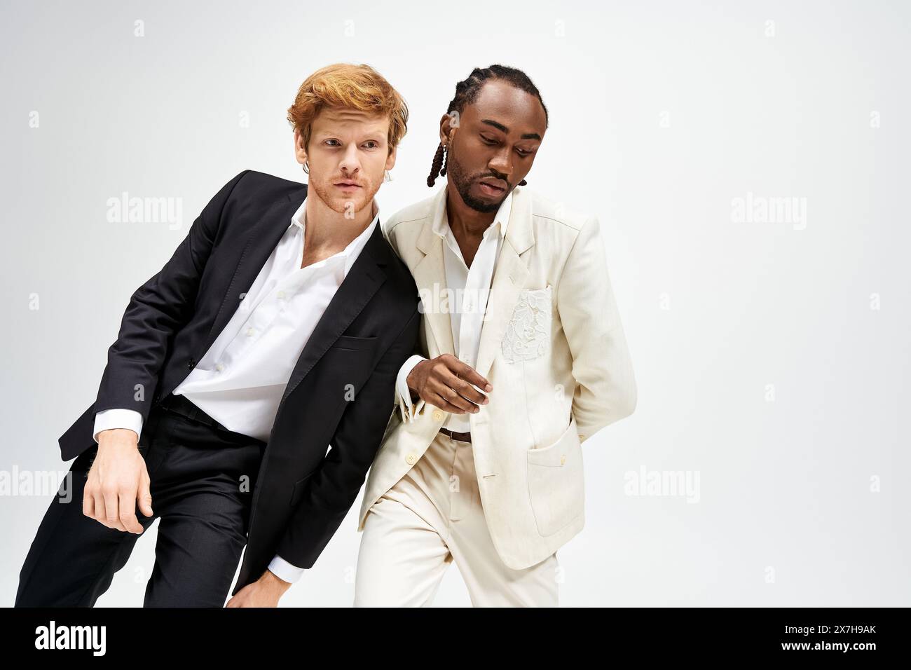 Two multicultural men in sharp suits striking a confident pose Stock ...