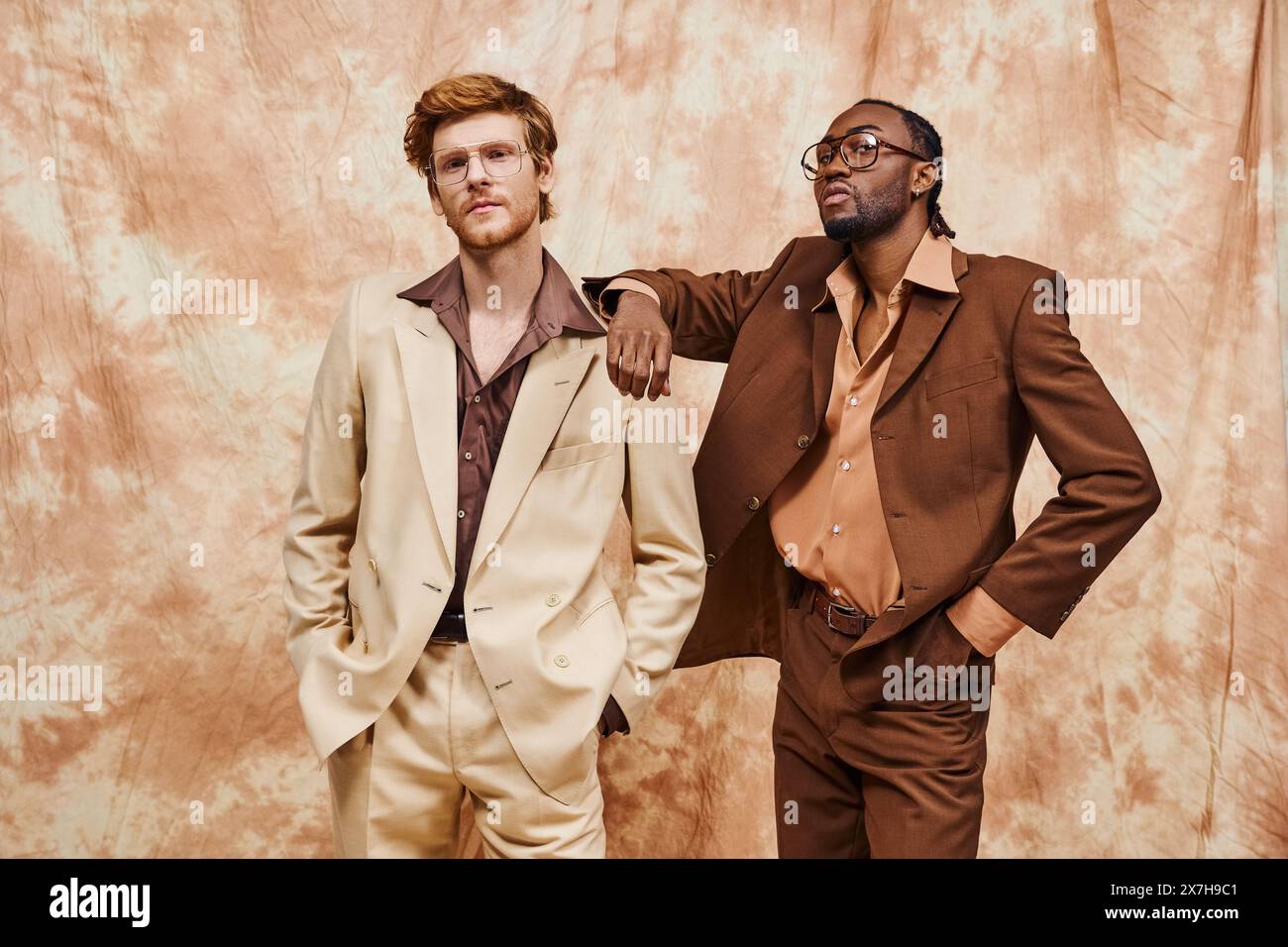 Two elegant multicultural men in stylish suits standing side by side ...