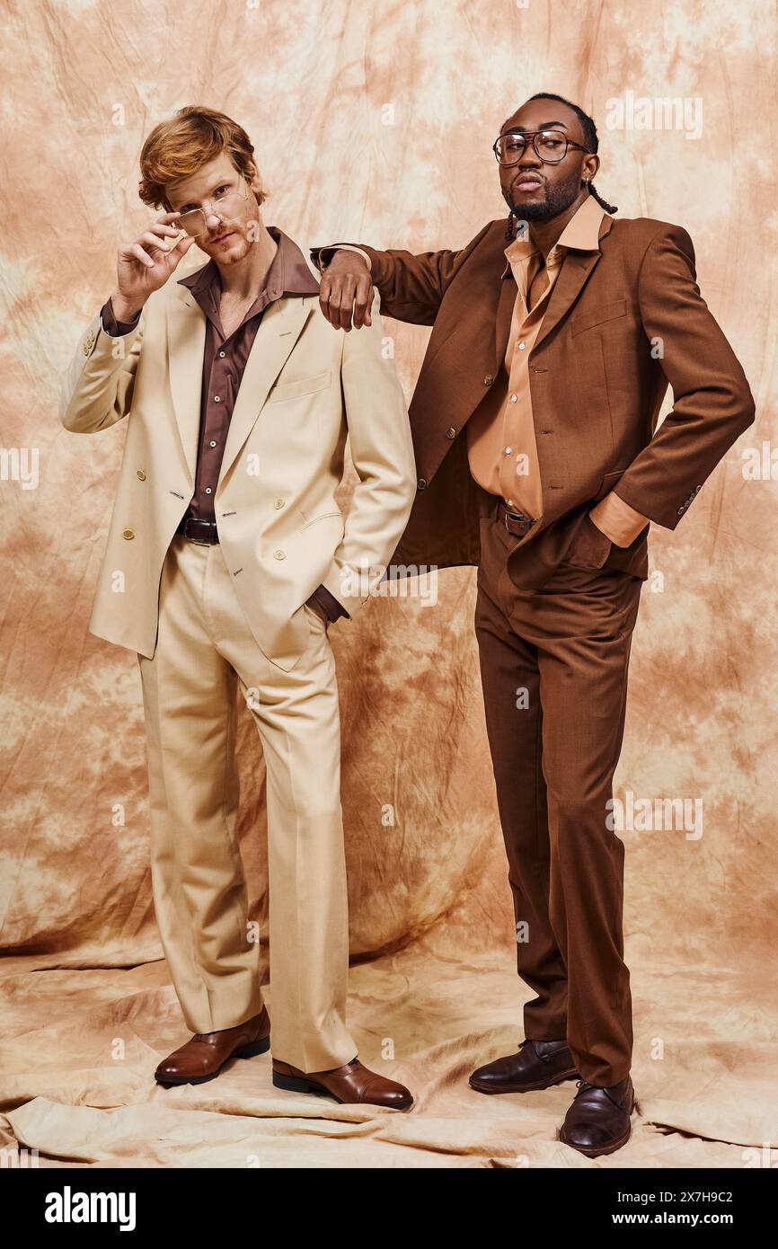 Two elegant men standing side by side in stylish suits Stock Photo - Alamy