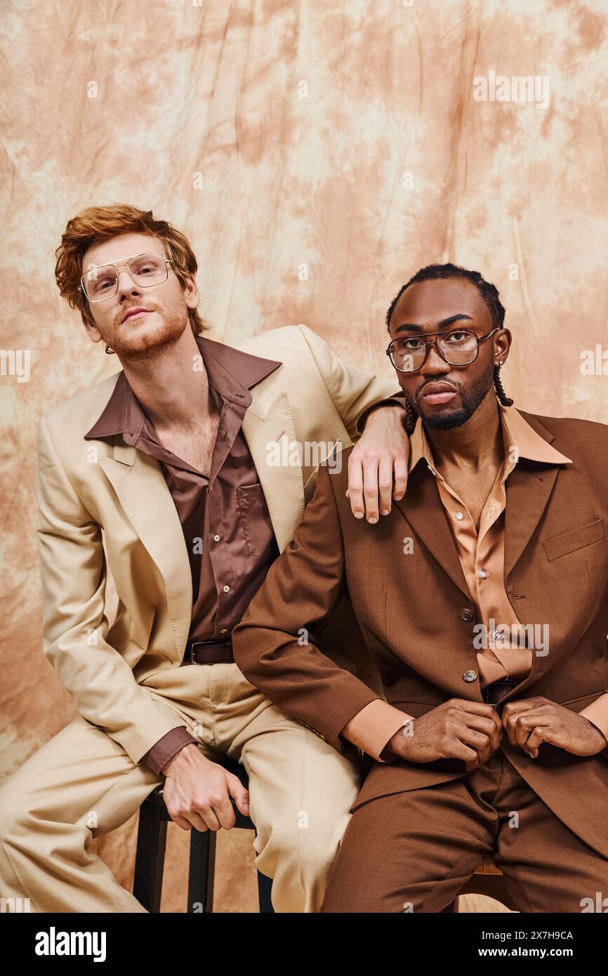 Two multicultural men with elegant style sitting together Stock Photo ...