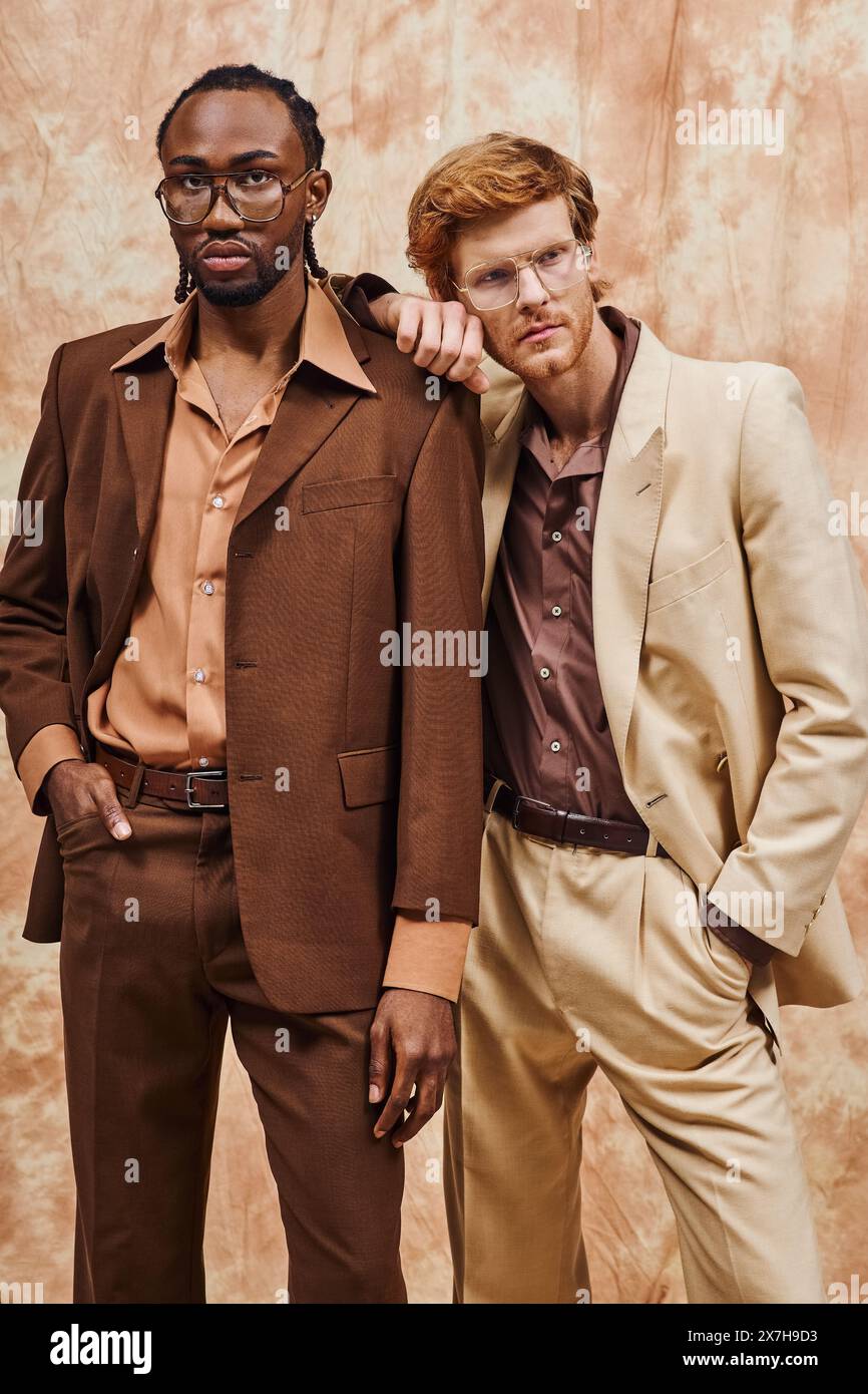 Two elegant, multicultural men in stylish suits standing side by side ...