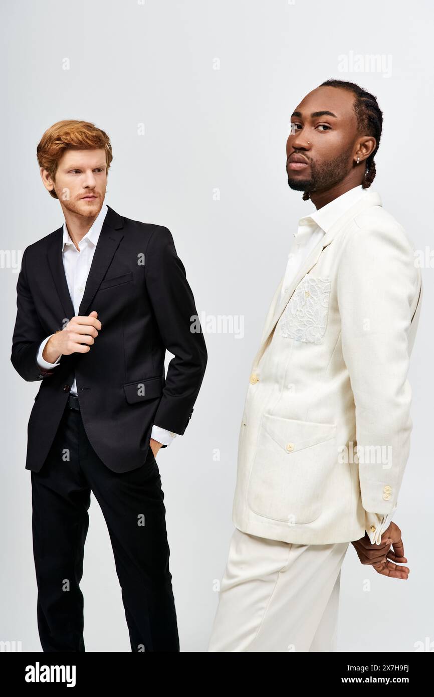 Two handsome men in dapper suits stand side by side Stock Photo - Alamy