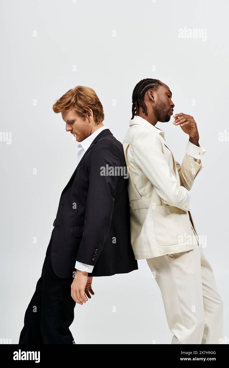 Two multicultural men in elegant suits pose side by side Stock Photo ...