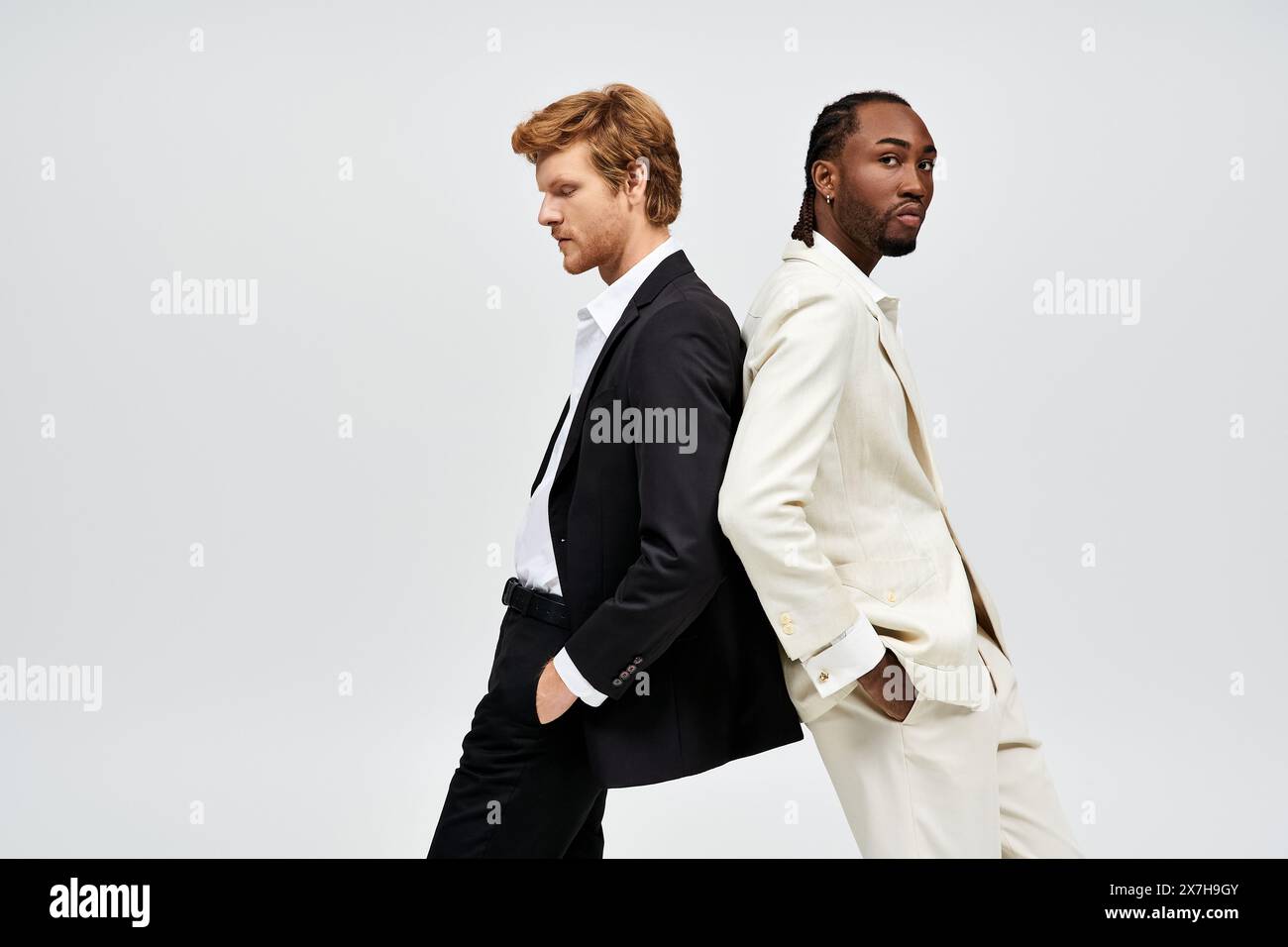 Handsome multicultural men in elegant suits posing side by side Stock ...