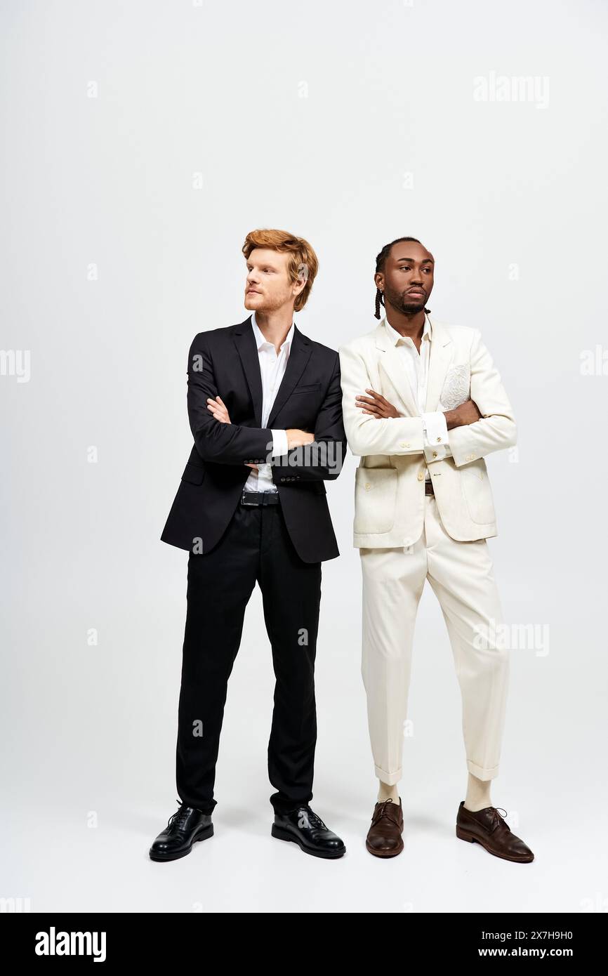 Two handsome multicultural men in elegant suits standing together Stock ...