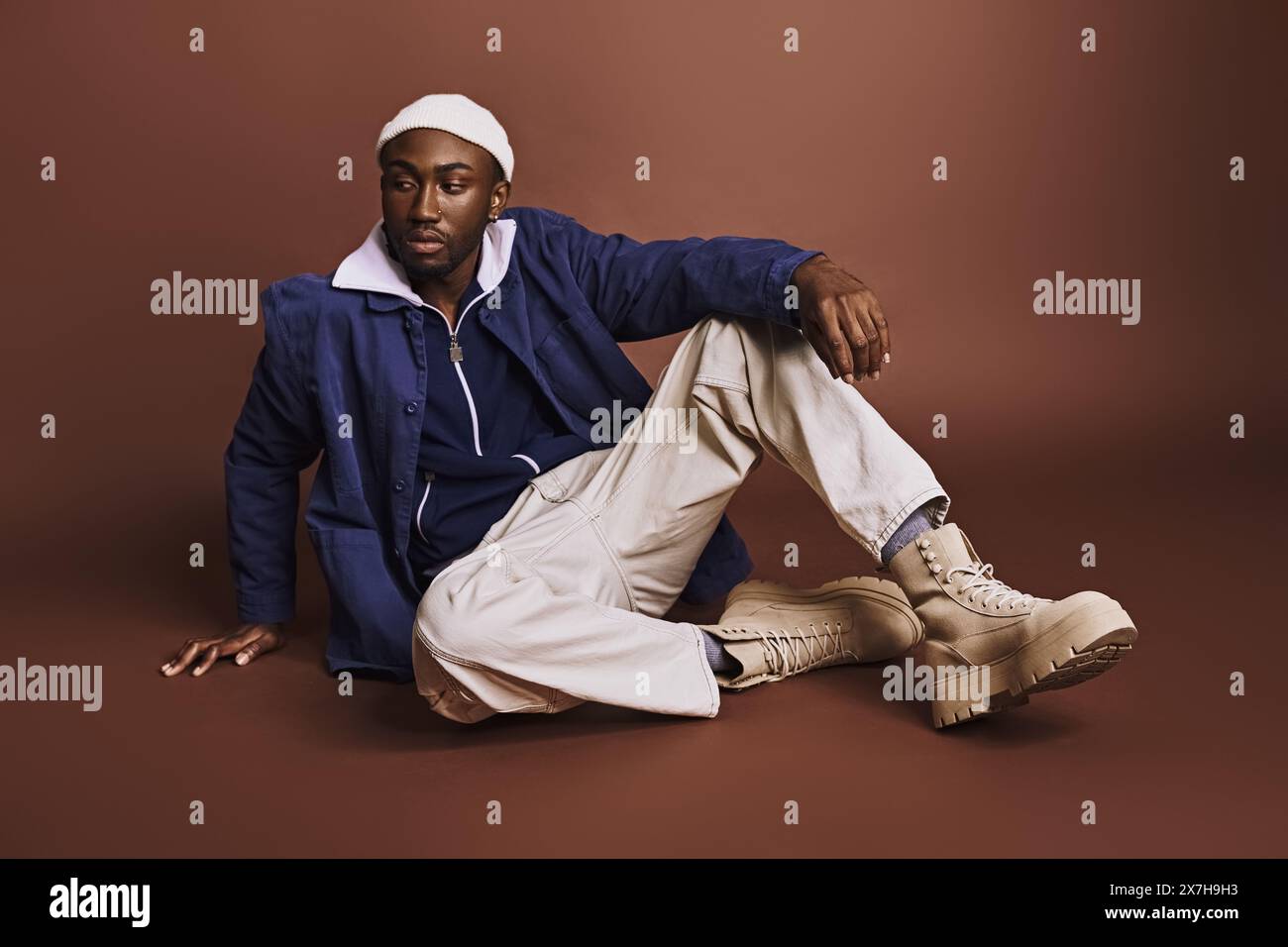 Young African American man sitting cross-legged on ground Stock Photo ...