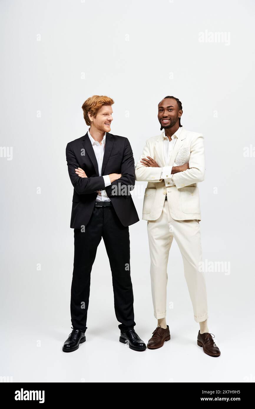 Two handsome multicultural men in elegant suits pose together Stock ...
