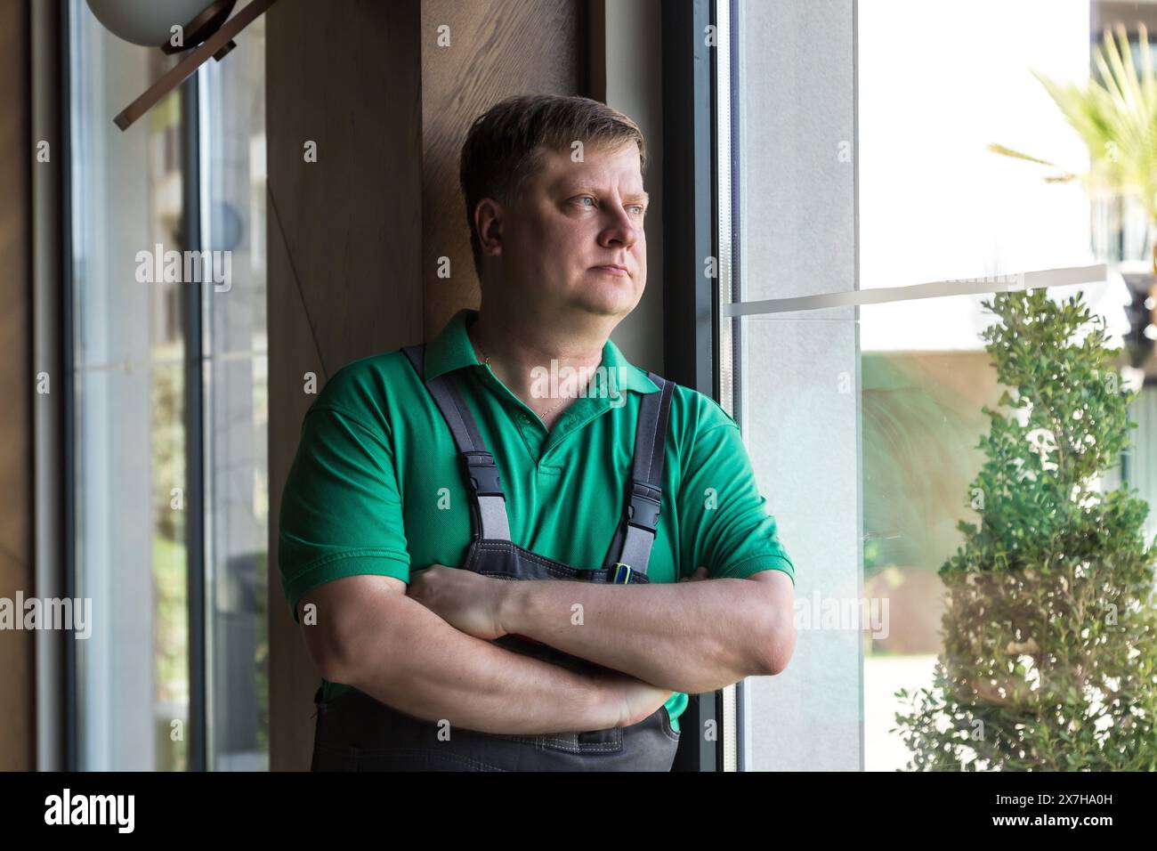 Professional worker in green overalls hi-res stock photography and ...
