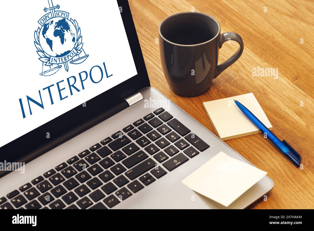 20 May 2024: Laptop computer on a desk with Interpol logo on the screen ...