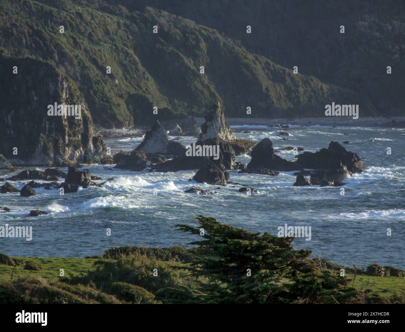 Rocks in the Pacific Ocean off the western shore of Chiloe Island in ...