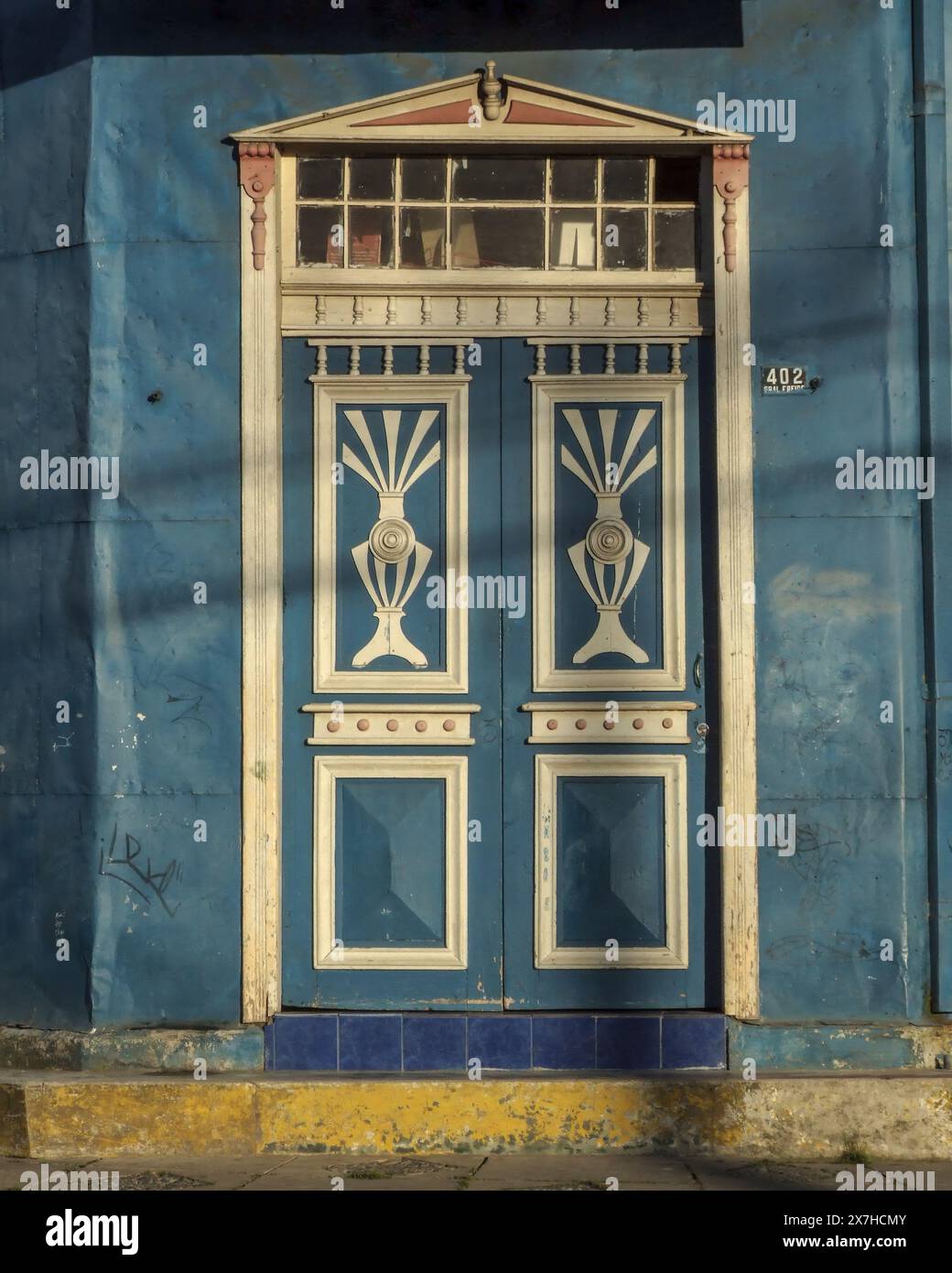 Detail of the door of a painted, metal-sheathed Victorian building in ...