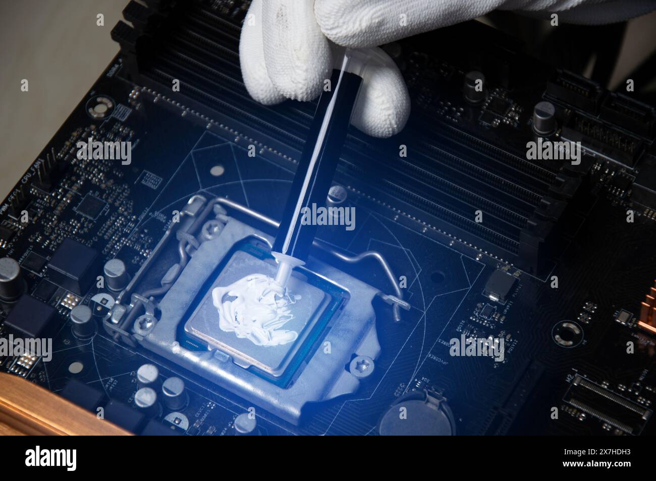 The technician is adding thermal silicone to the CPU chip Stock Photo ...