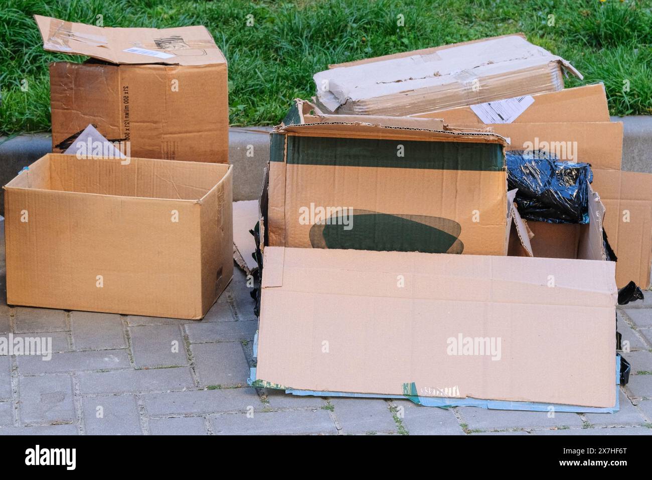 Cardboard and waste paper is packaged for recycling. Pile of cardboard ...