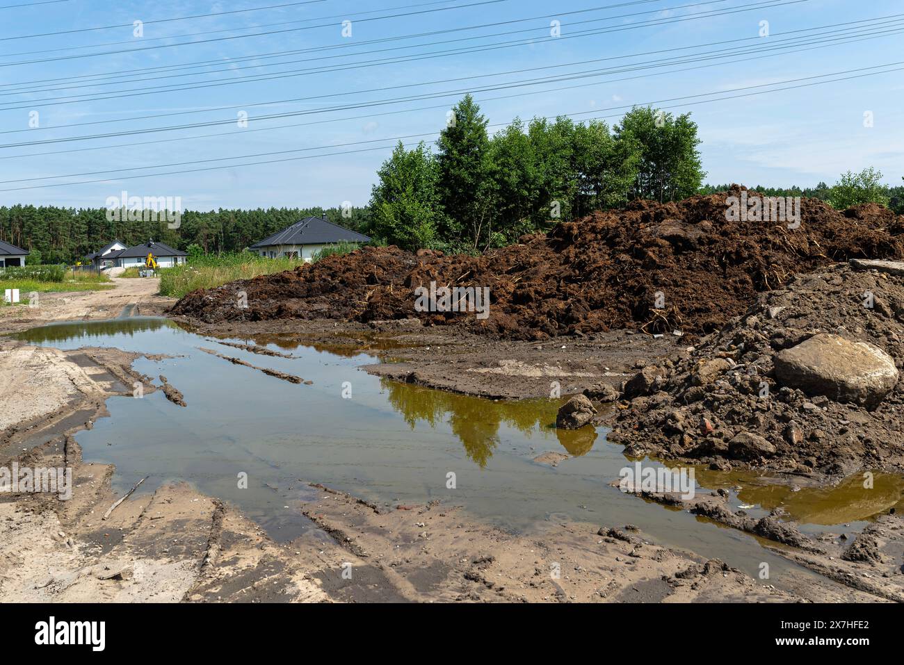 Digging out peat from marshy swamps, visible mountains made of peat ...
