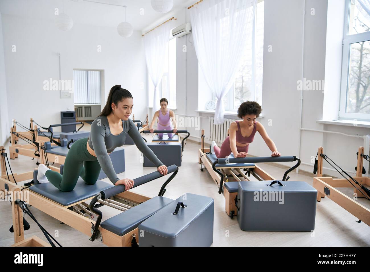 Diverse women engaging in a pilates class, focusing on strength and ...