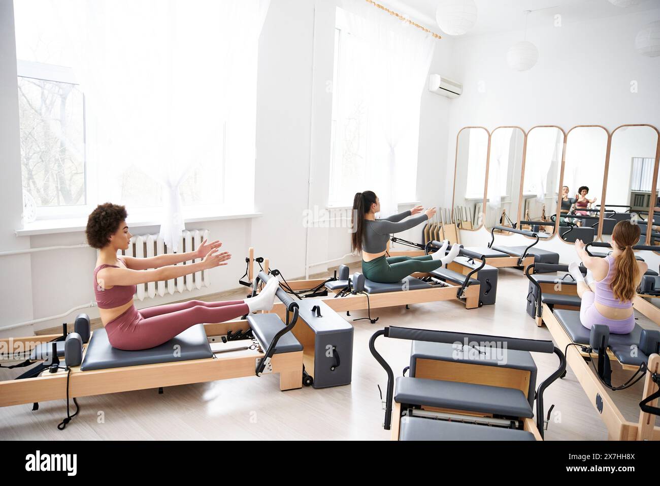 Women engaging in Pilates exercises in a group setting Stock Photo - Alamy