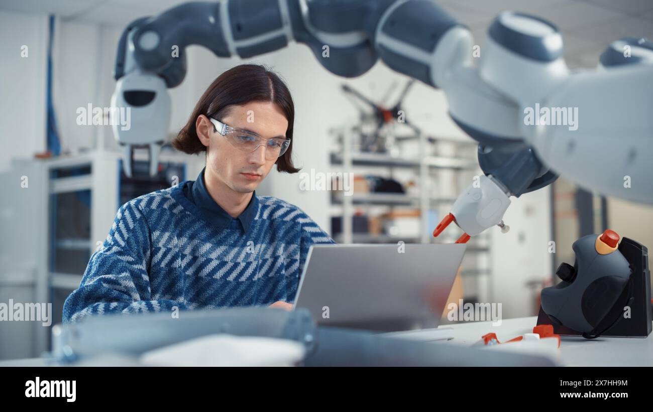Male Developer Programming Robotic Arm on Laptop. Robotics Engineer ...