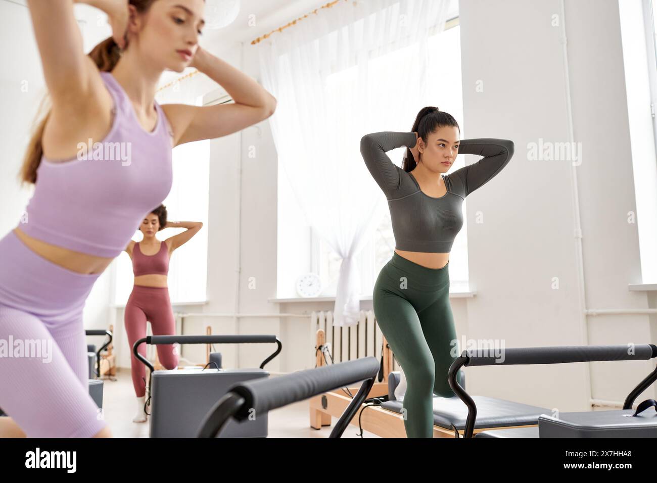 A group of women stand together in a gym, ready to empower and support ...