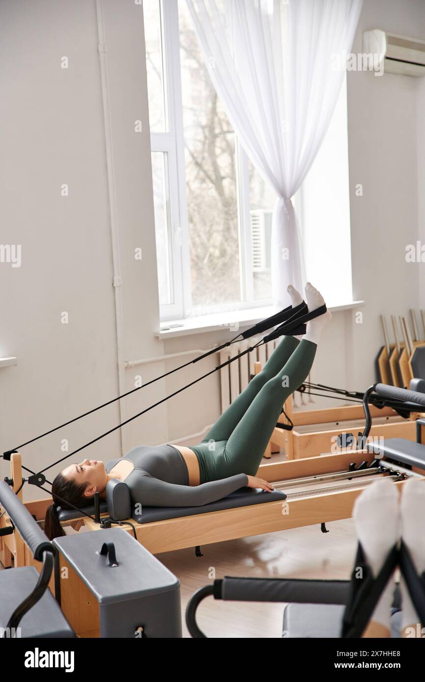 Beautiful woman on a pilates lesson Stock Photo - Alamy