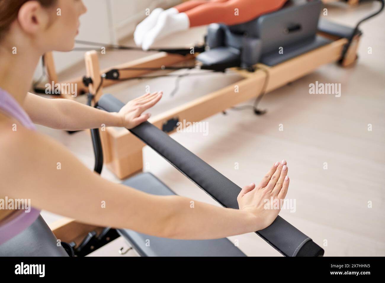 A sporty woman engages in a pilates lesson in the gym Stock Photo - Alamy
