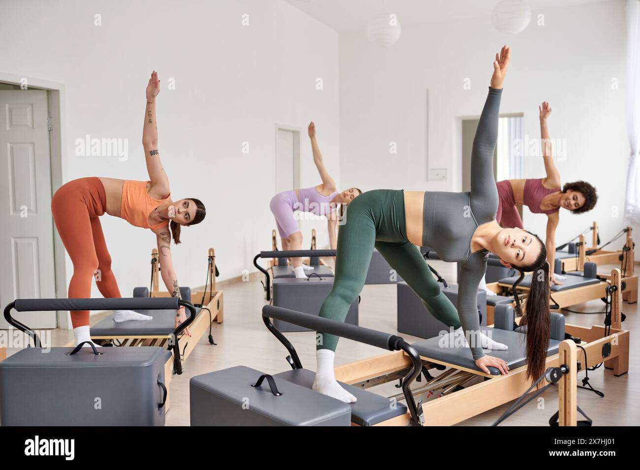 A dynamic group of pretty sporty women in a gym engaging in various ...