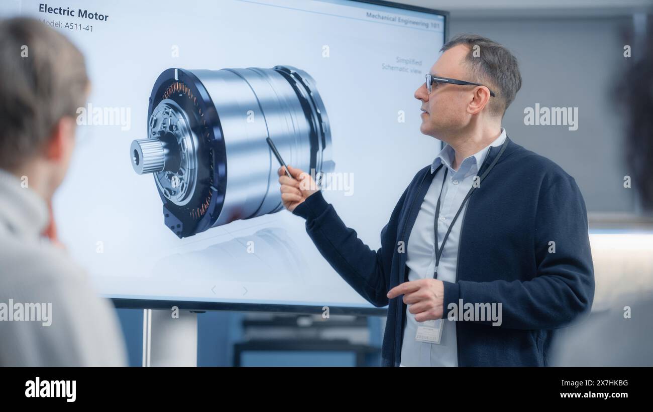 Male Chief Engineer Talks to Young Specialists About Components of the ...