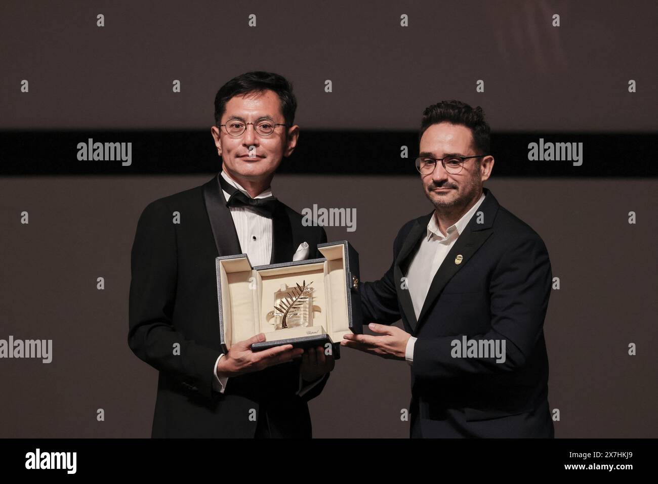 Cannes, France. 20th May, 2024. Goro Miyazaki (L) receives the award from jury member Juan ...