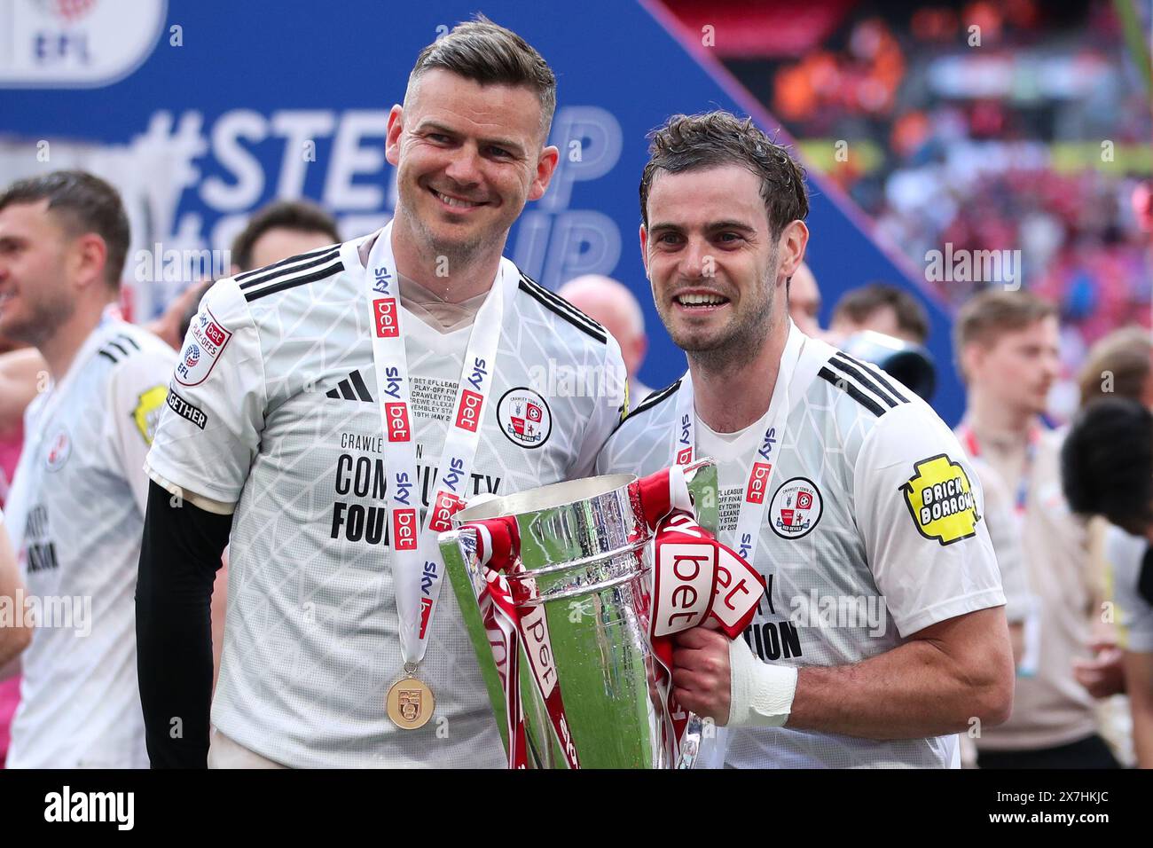 Crawley Town's Dion Conroy (right) poses with the trophy after the Sky ...