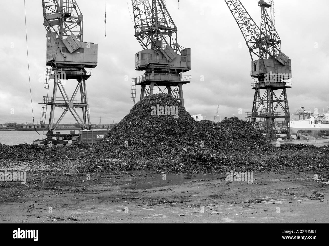 Dockside cranes and scrap metal Stock Photo - Alamy