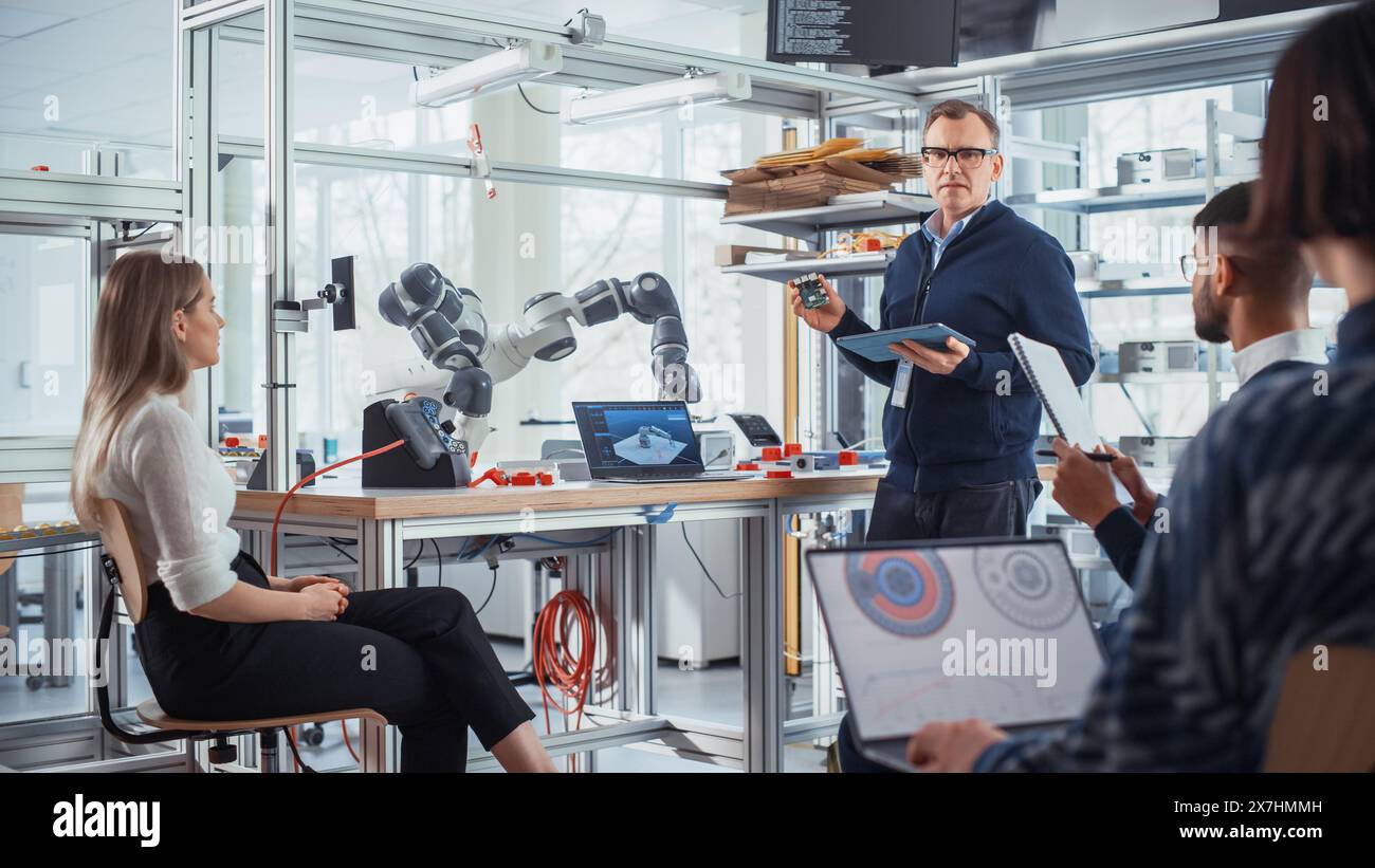 Chief Engineer Holds Tablet and Talks to Diverse Team of Computer ...