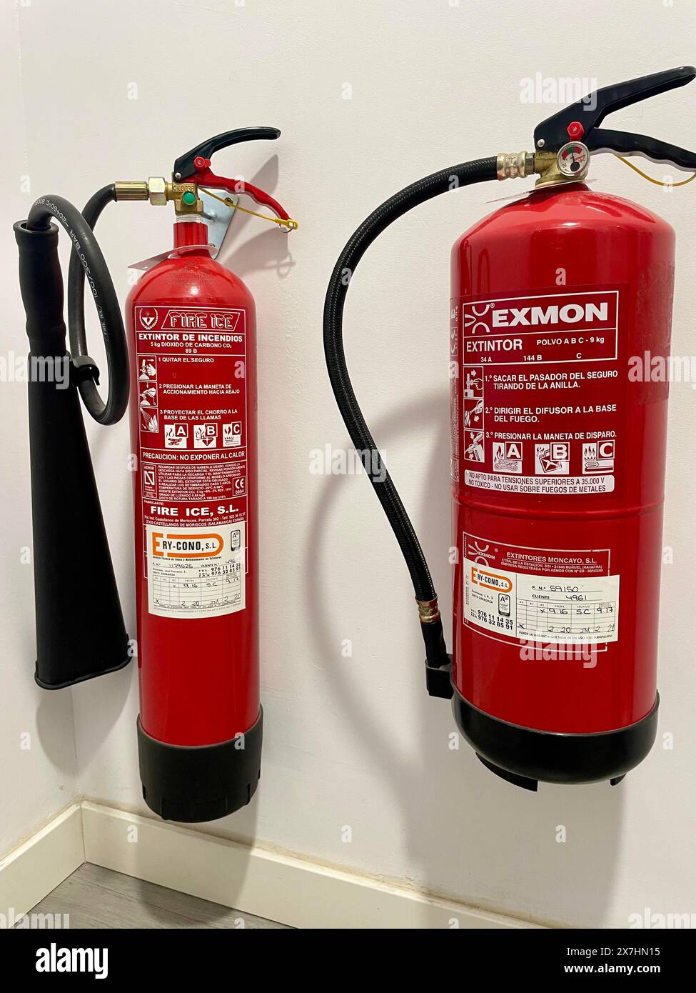Two fire extinguishers on the wall Stock Photo - Alamy