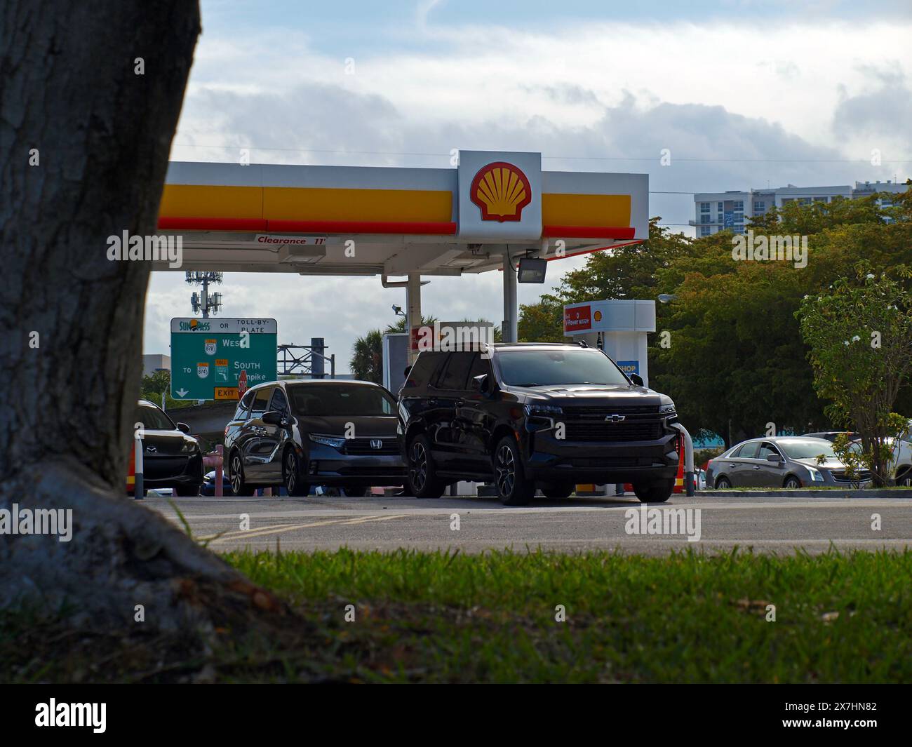 Miami, Florida, United States - April 6, 2024: Vehicles in a Shell gas ...