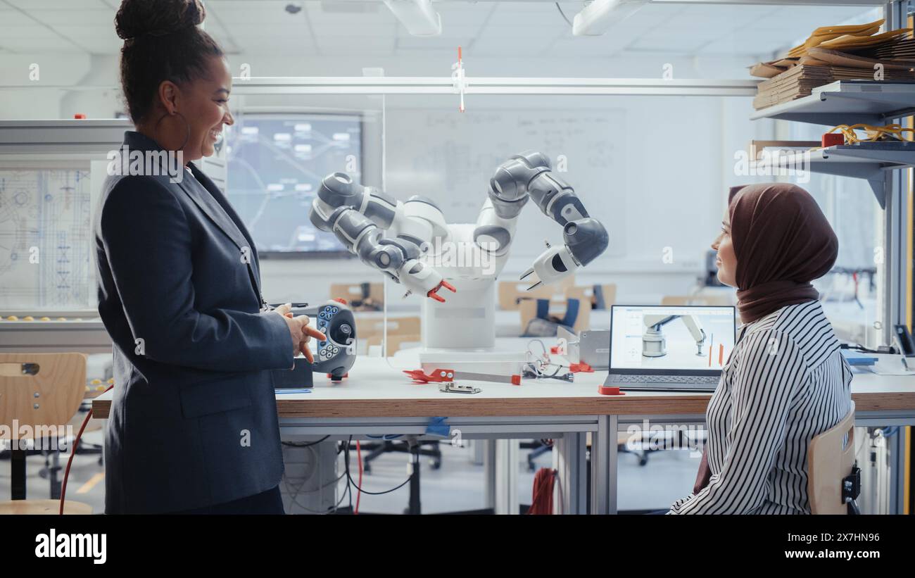 Black Senior Engineer Manipulating Robot Arm with Controller. Explain ...