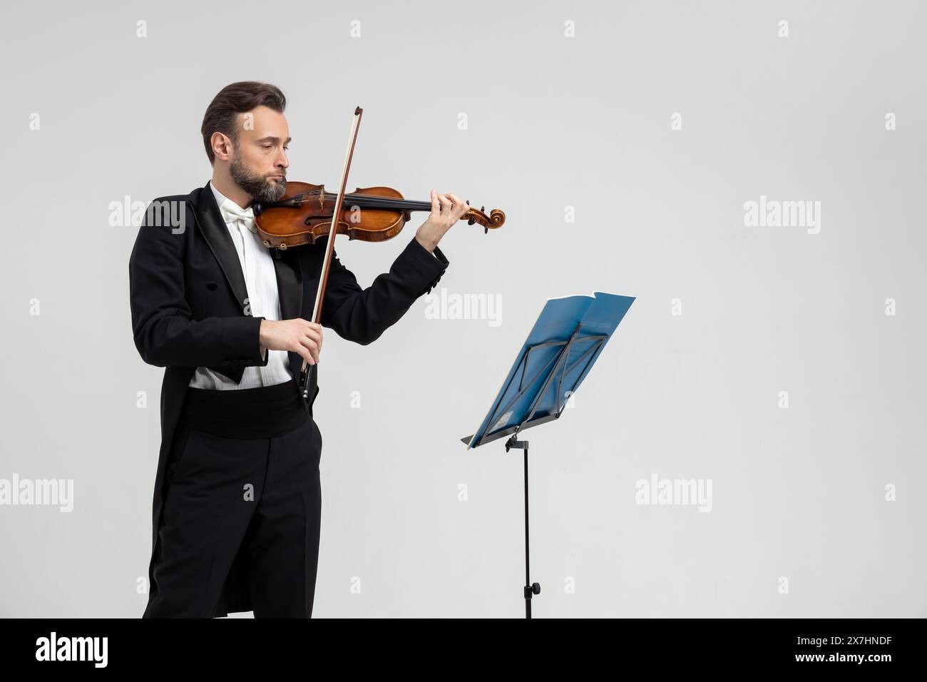 Bearded male violinist playing violin in front of sheet music Stock ...