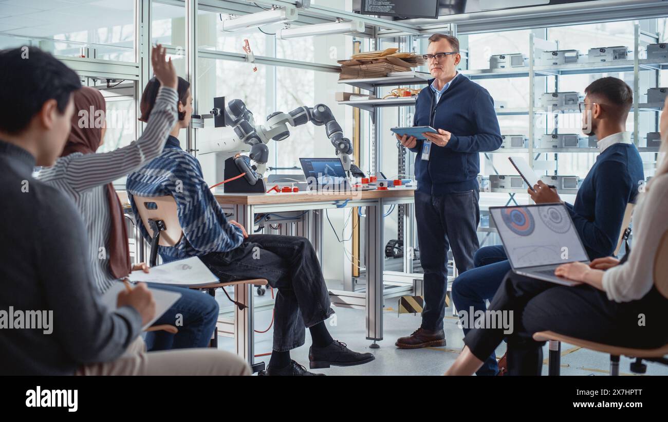 University Robotics Lecture: Teacher Explaining Engineering to Students by Using Robot Arm ...