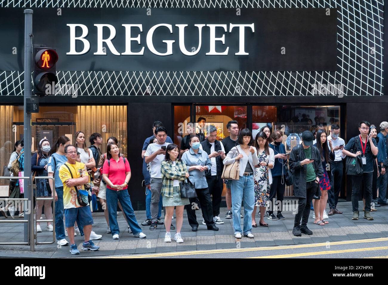 Hong Kong, China. 20th May, 2024. Pedestrians wait at a traffic light ...