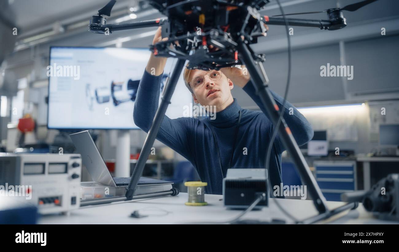 Young Caucasian Male Engineer Installs Powerful Processor in the Drone ...
