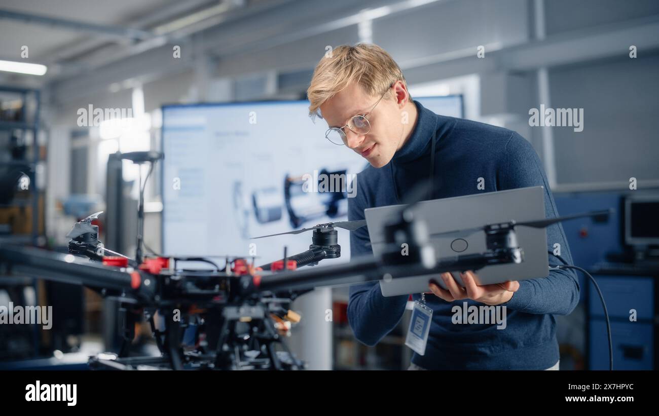 Male Developer Works on Engineering Project, Codes on Laptop and Looks ...
