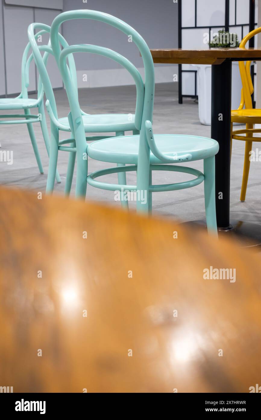 Colorful wooden chairs and tables in a public restaurant. Public places ...