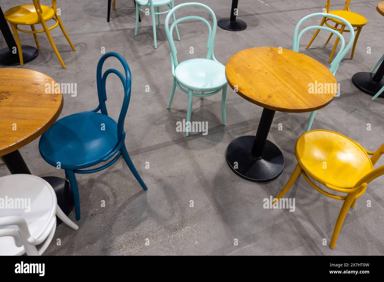 Colorful wooden chairs and tables in a public restaurant. Public places ...