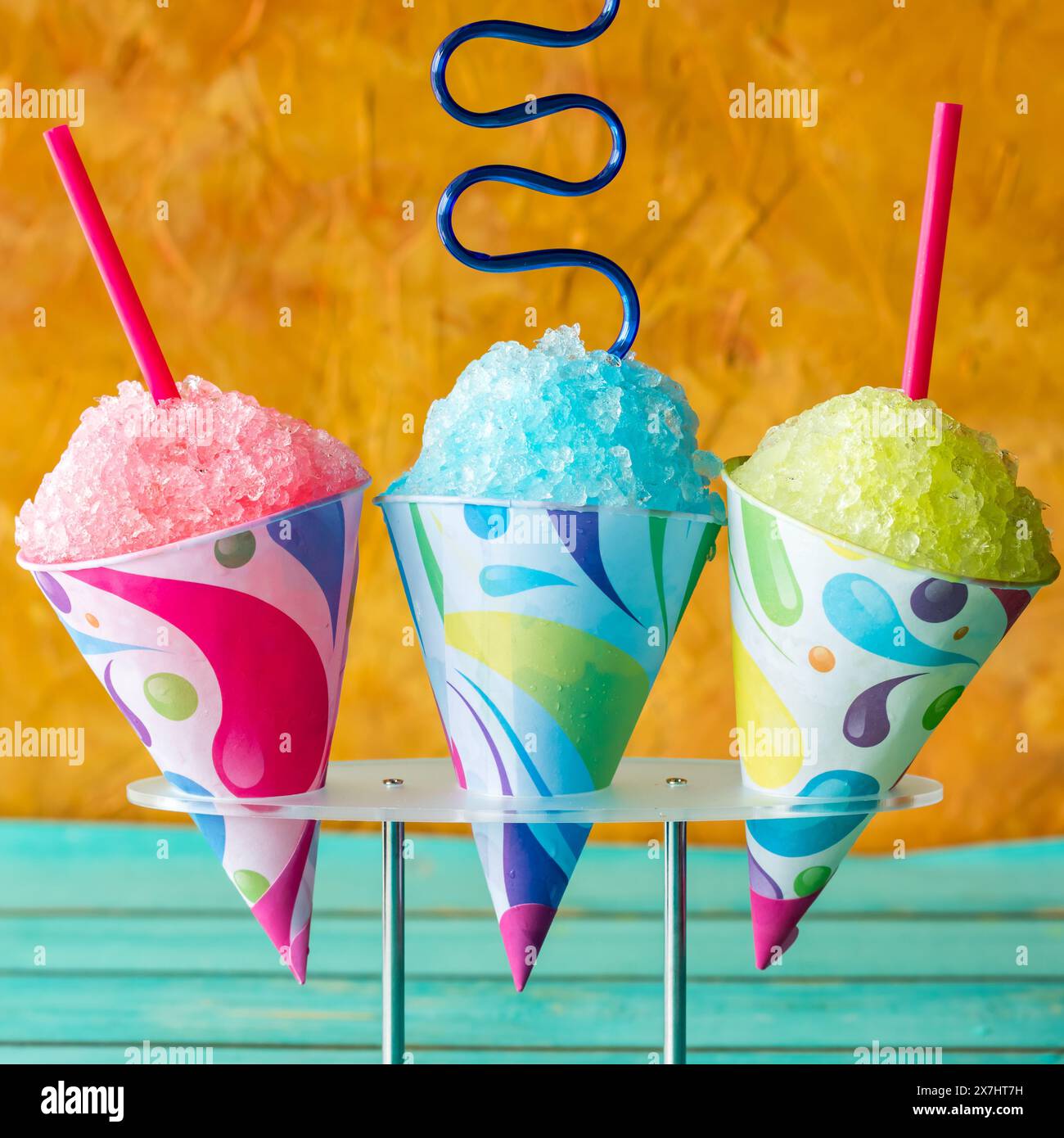 Three colourful fruit flavoured snow cones with straws Stock Photo - Alamy