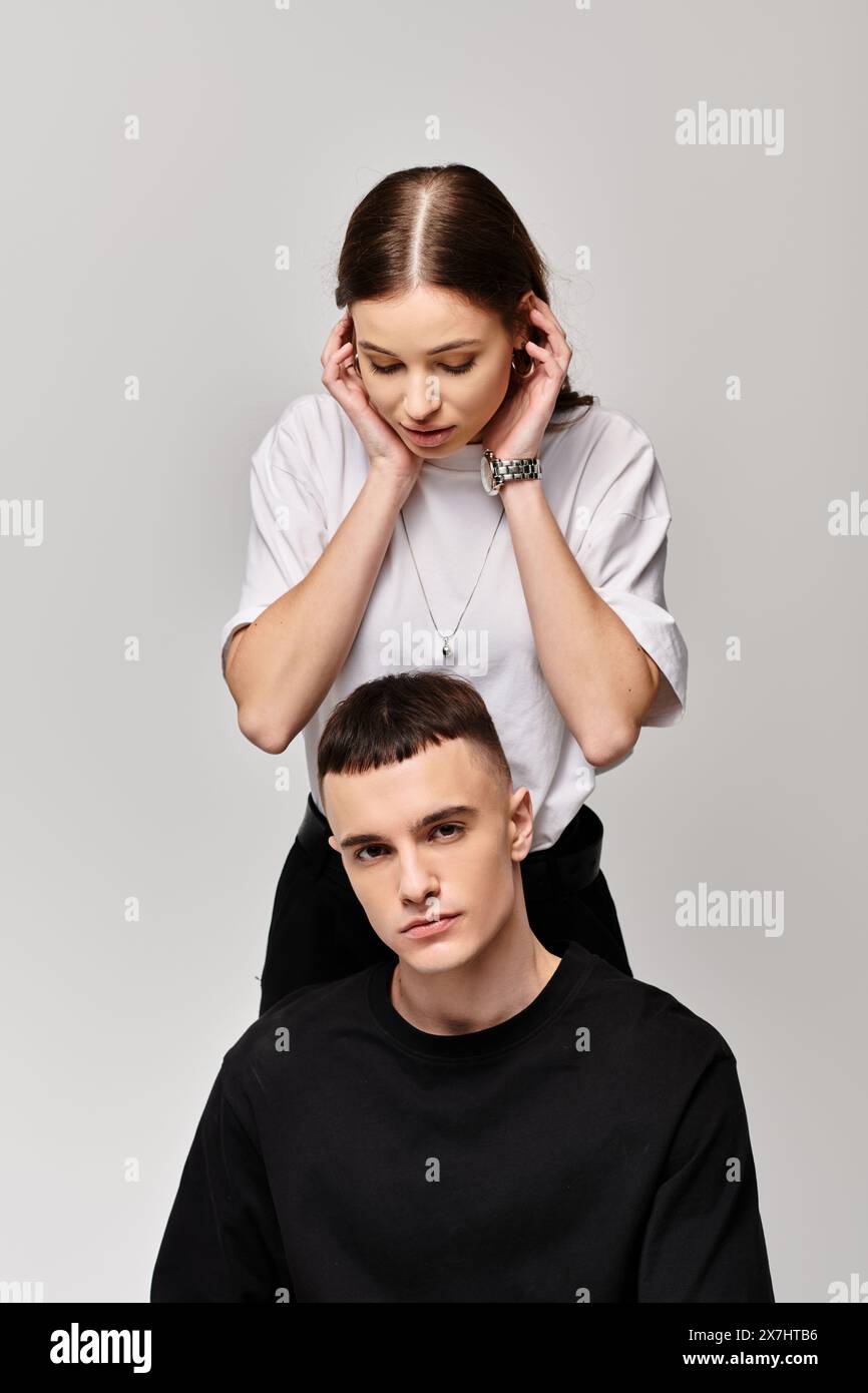 A man peacefully sits atop a womans head, their bodies intertwined ...