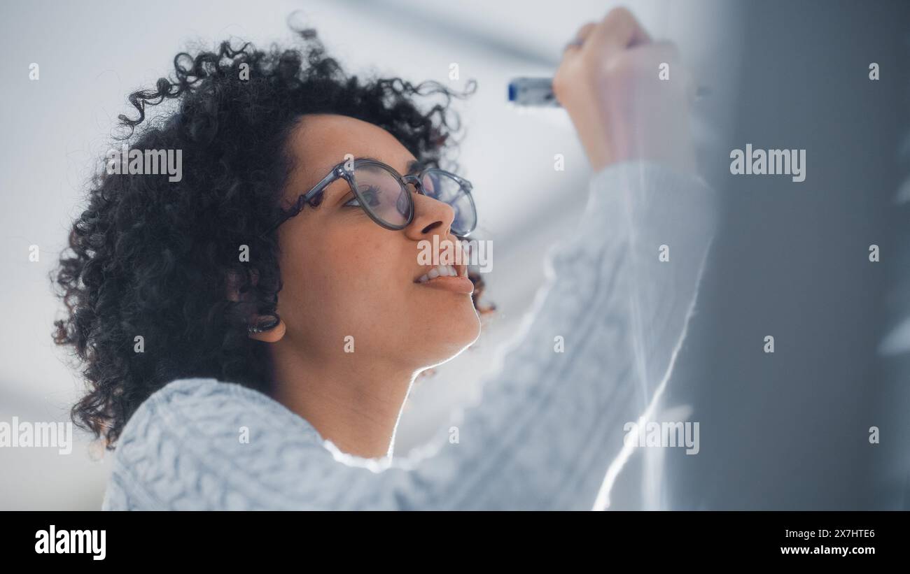 Intelligent Female Scientist Pondering and Writing Various High School ...