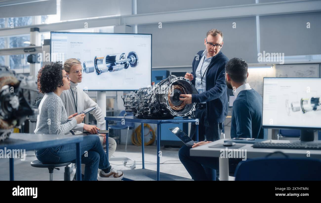 Team of Diverse Engineers Using Laptop and Tablet to Analyse Electric ...