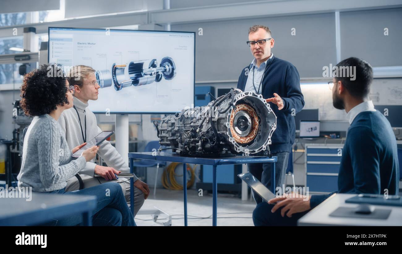 Team of Diverse Engineers Using Laptop and Tablet to Analyse Electric ...