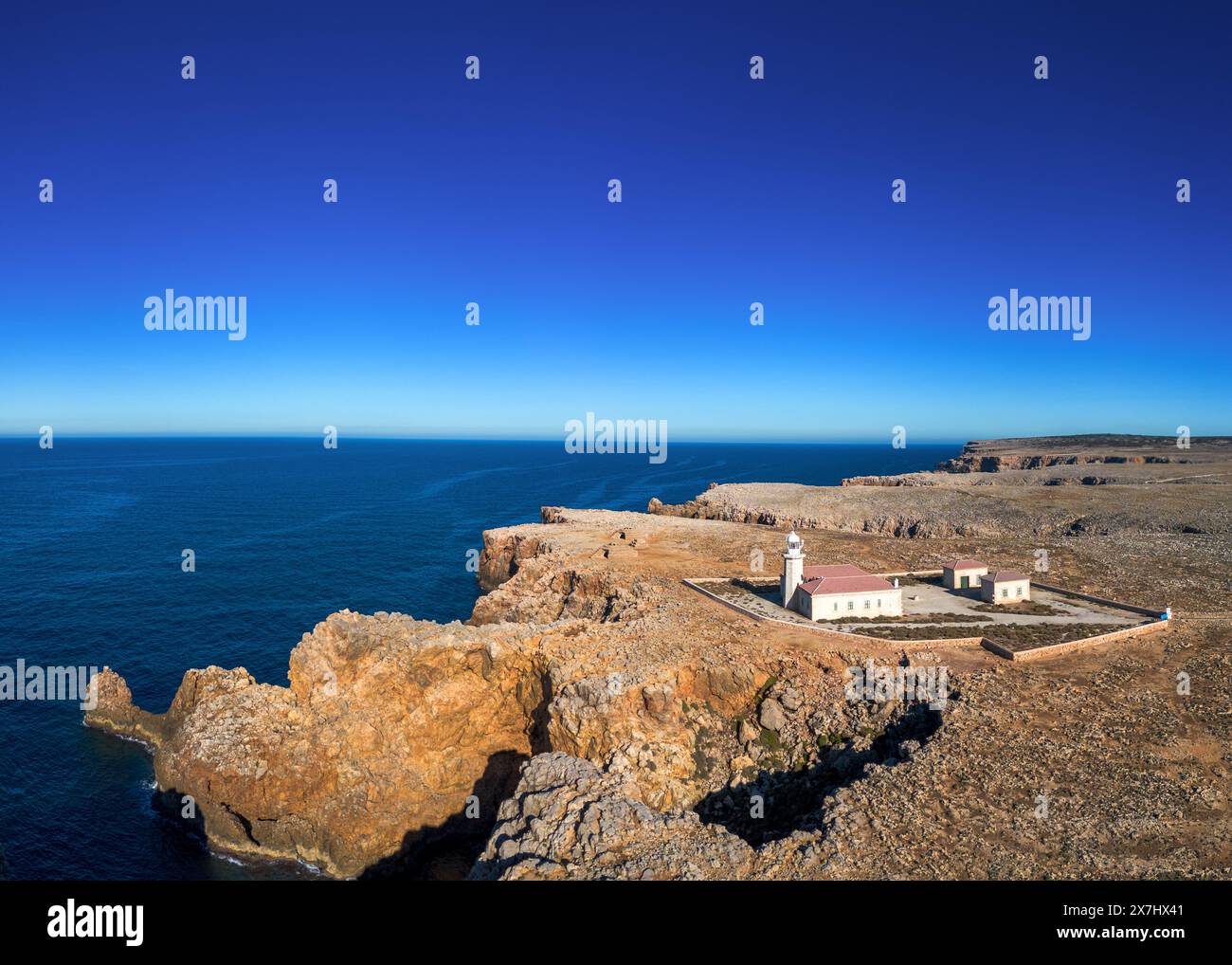 drone view of the Punta Nati lighthouse and coastal cliffs in ...