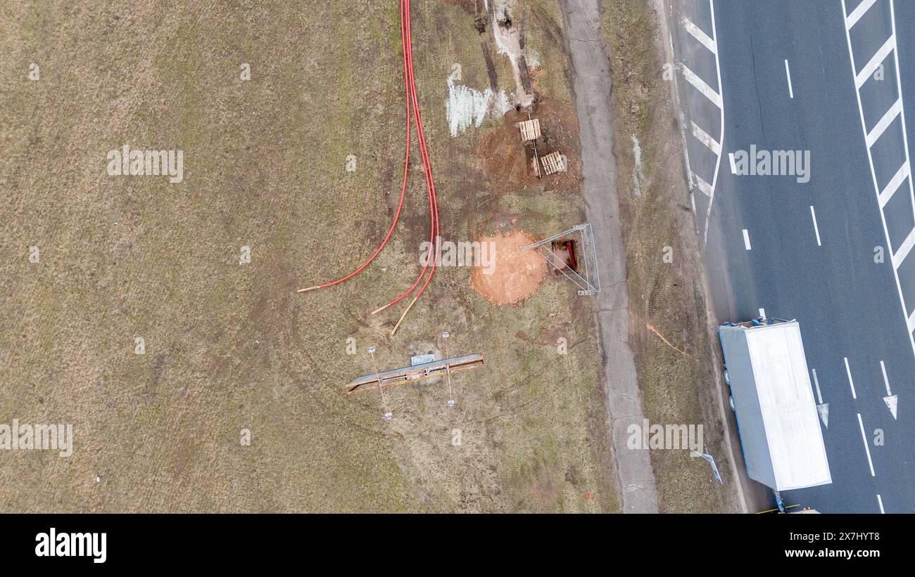 Drone photography of construction workers, industrial machinery laying ...